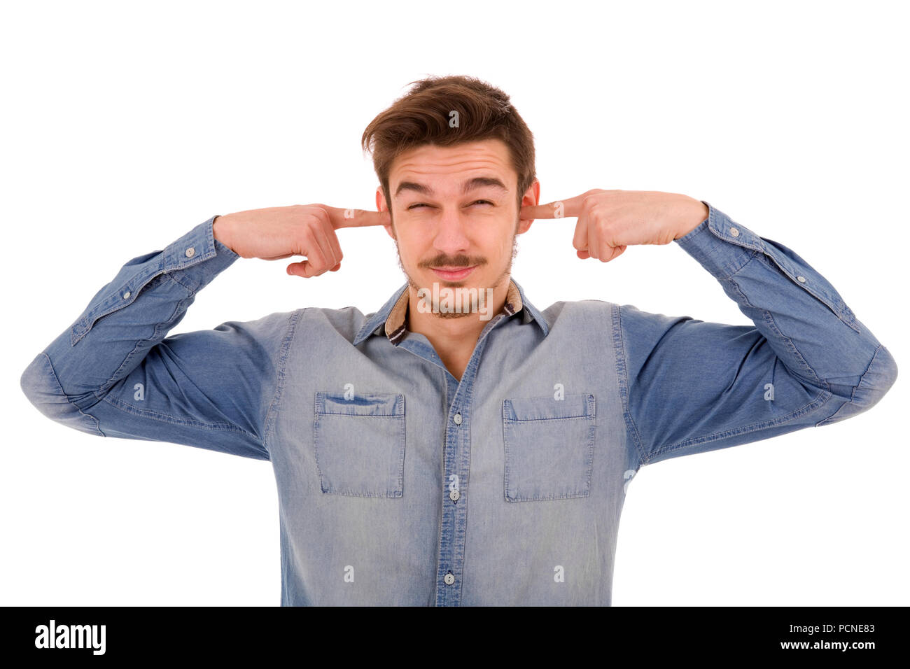 portrait of handsome young man covering his ears, isolated white ...