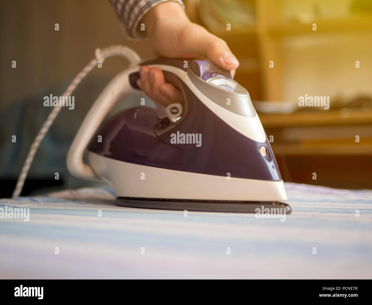 Woman ironing bed hi-res stock photography and images - Alamy