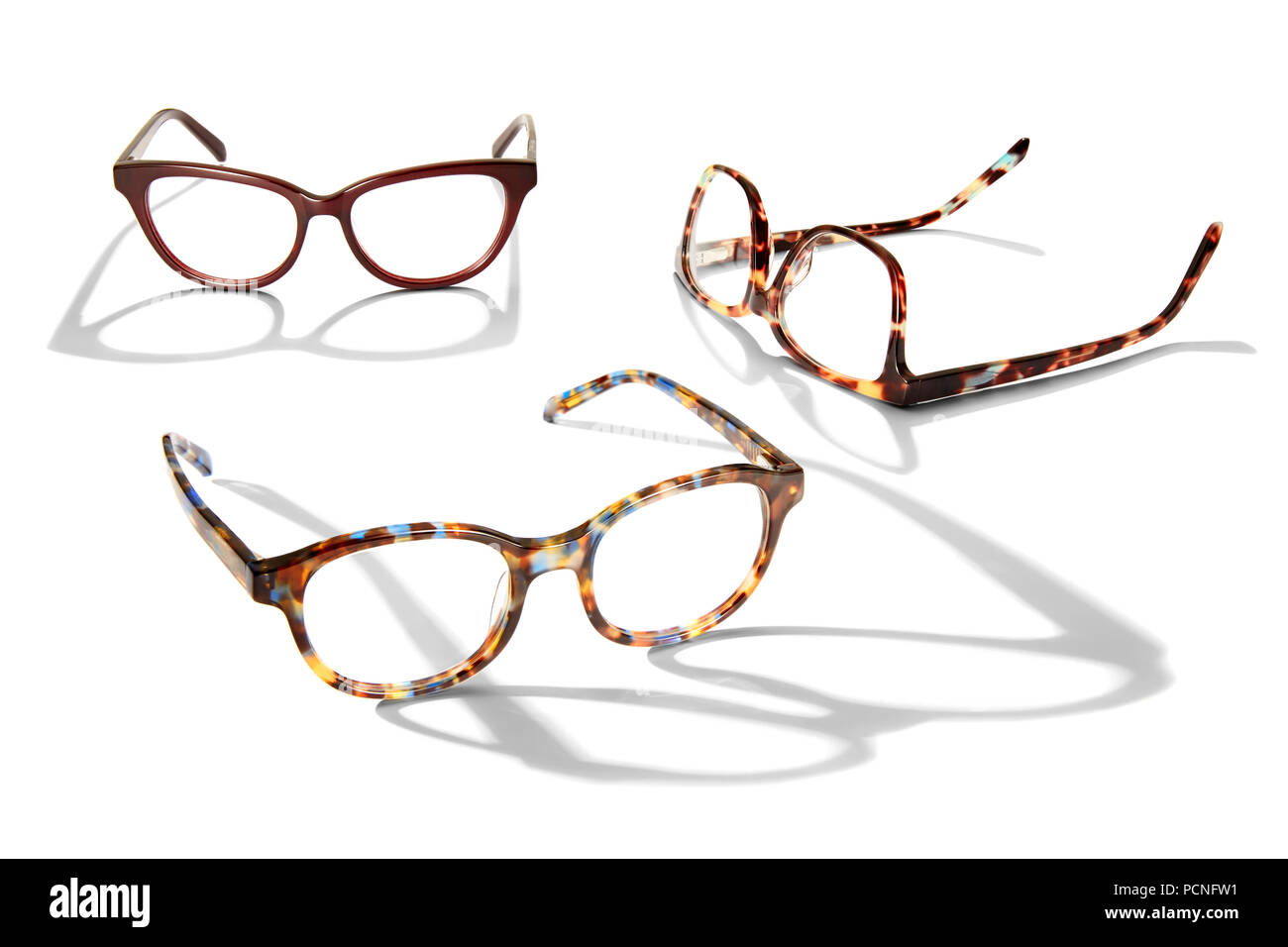 Studio photo of three pairs of glasses with long shadow isolated on ...