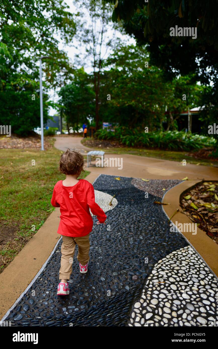 A Child walking on a path, Cardwell, Queensland, Australia Stock Photo ...