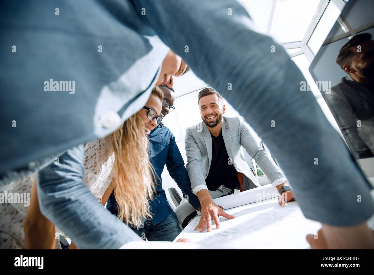 Group designers meeting around table hi-res stock photography and ...