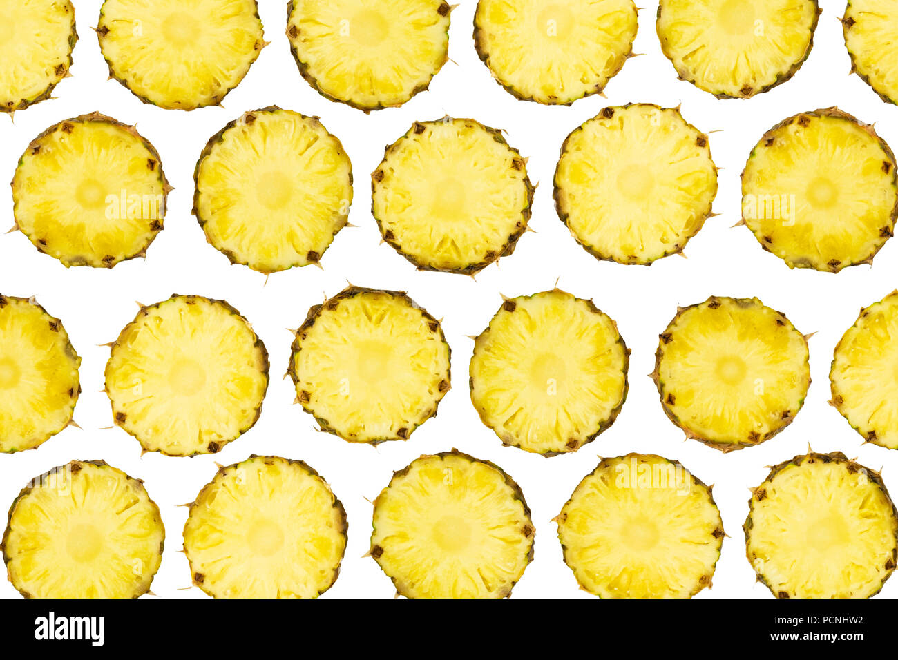 Sliced pineapple pieces lay in pattern on isolated white background ...