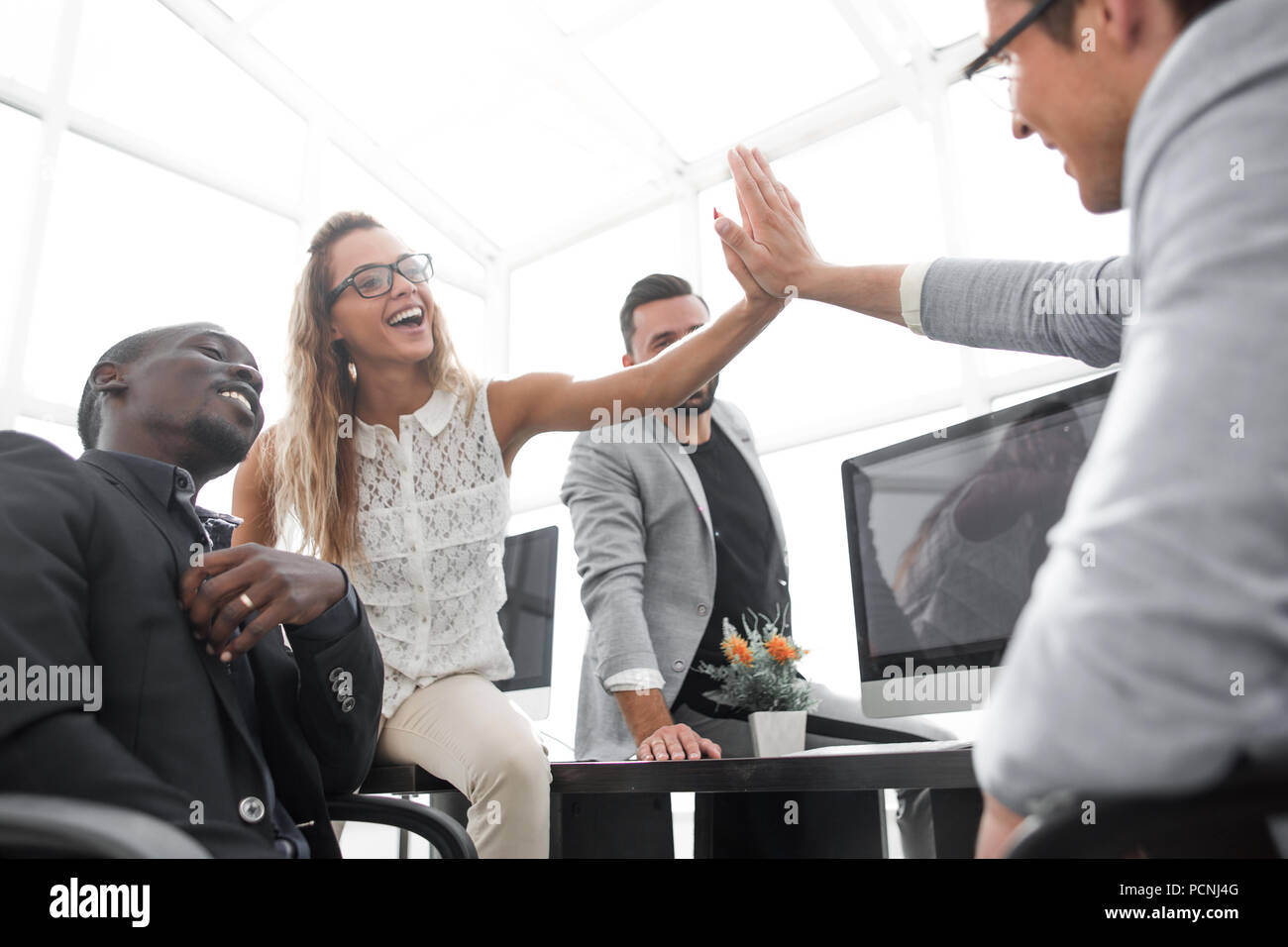 employees greet each other in the office Stock Photo - Alamy