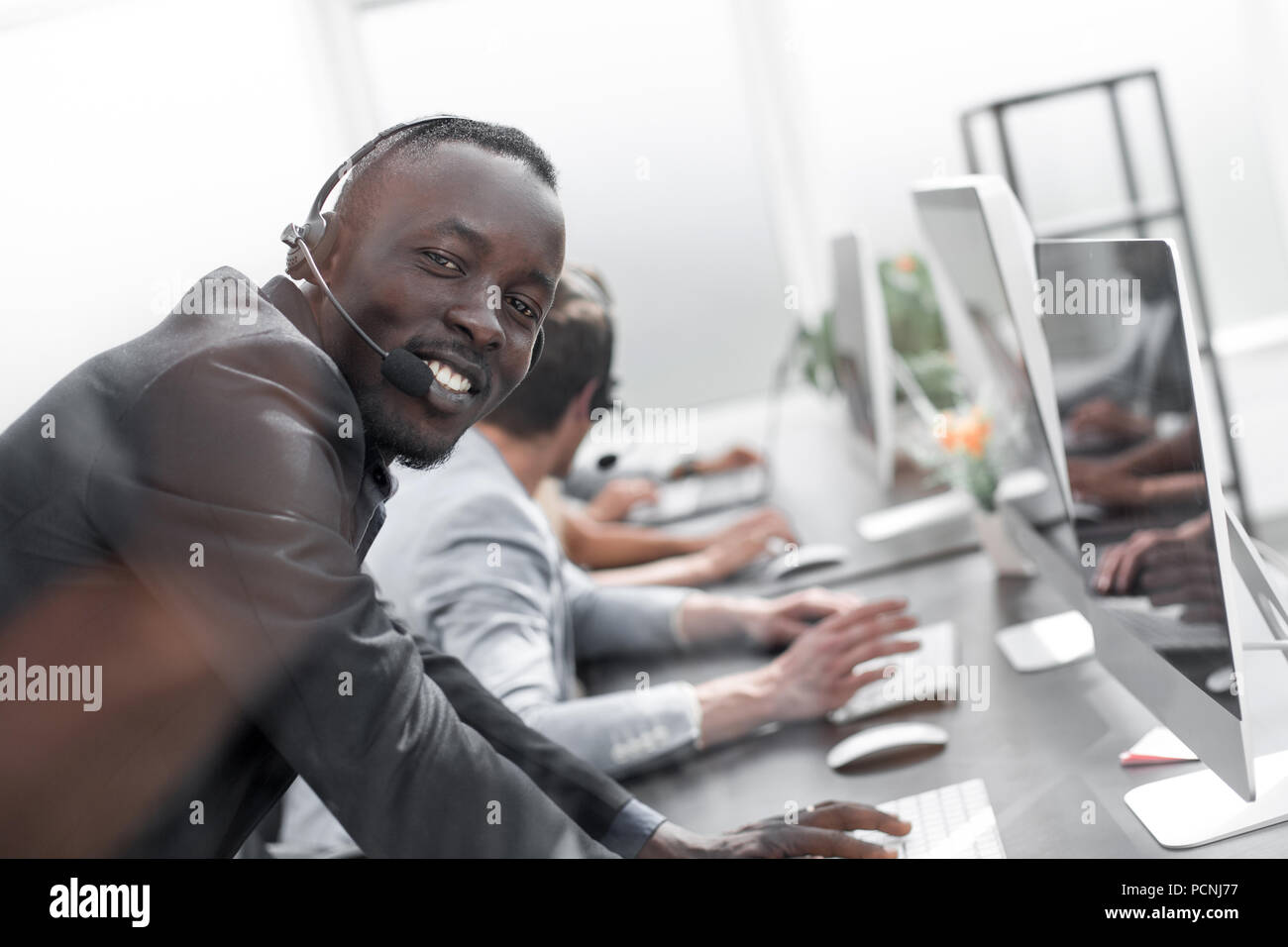 close up.call center operator on blurred background Stock Photo - Alamy