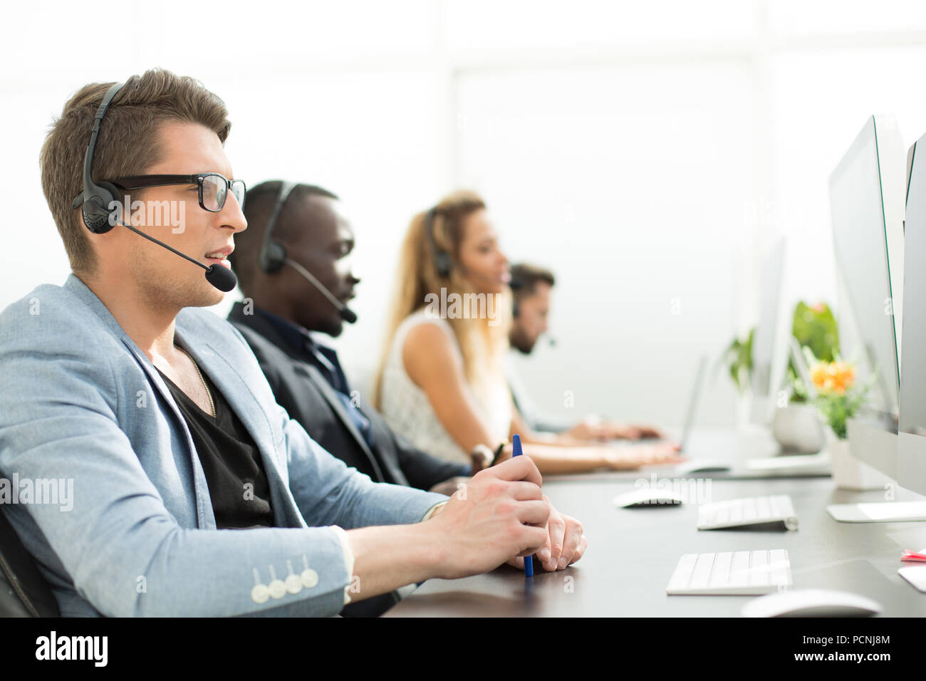 in the foreground .employee call center in the office Stock Photo - Alamy