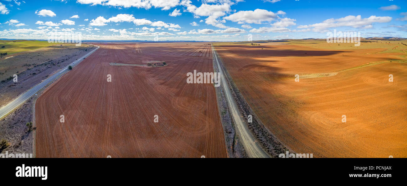 Wide aerial panorama of agricultural fields under beautiful blue sky ...