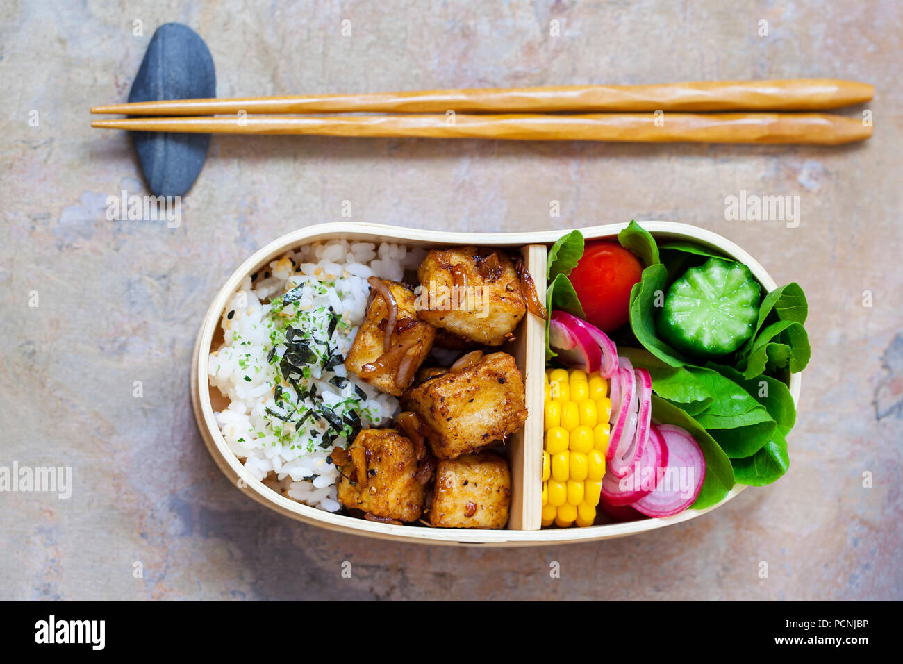 Crispy tofu with rice and salad in bento box Stock Photo - Alamy