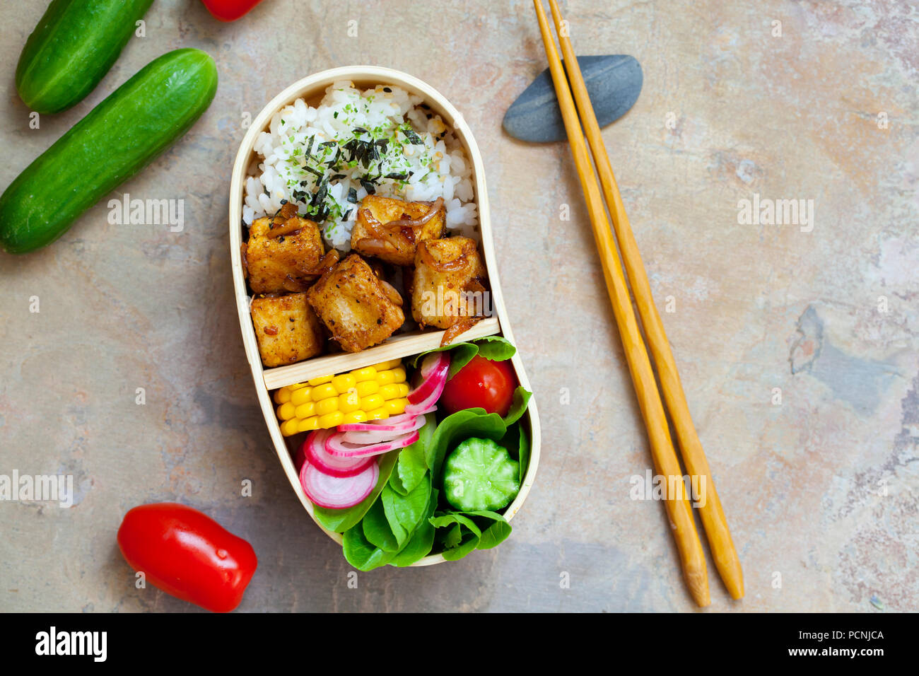 Crispy tofu with rice and salad in bento box Stock Photo - Alamy