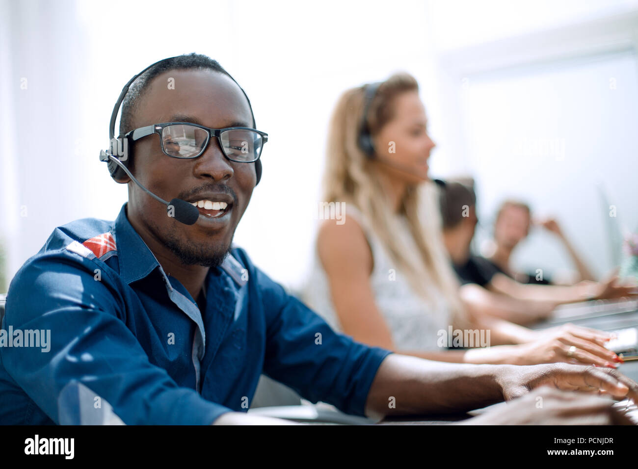 call center employee on the background of colleagues Stock Photo - Alamy