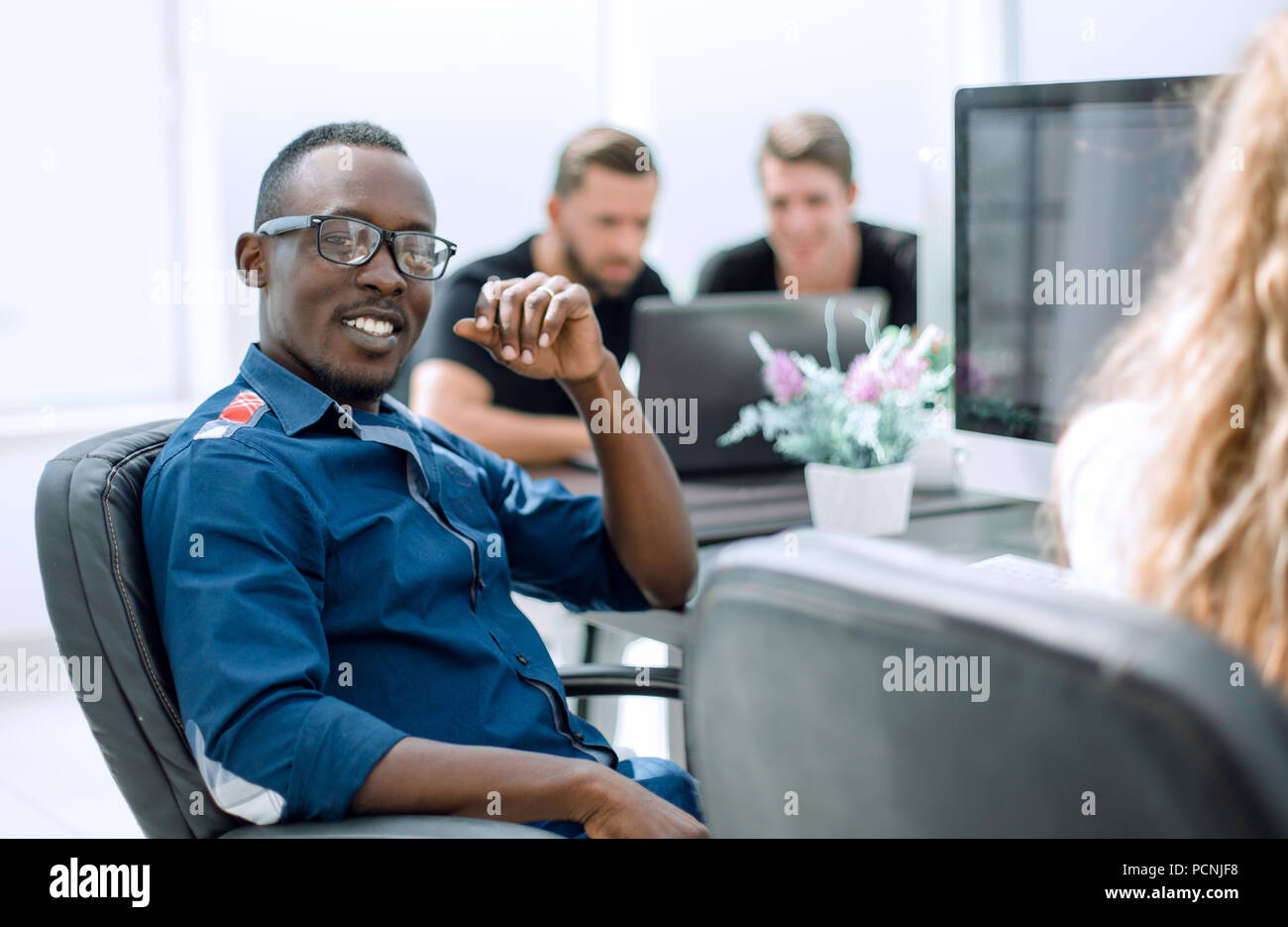 successful employee sitting at the Desk Stock Photo - Alamy