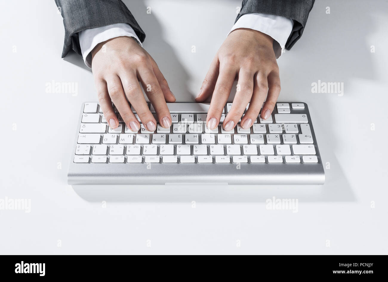 Closeup of businesswoman hand typing on keyboard with mouse on w Stock ...