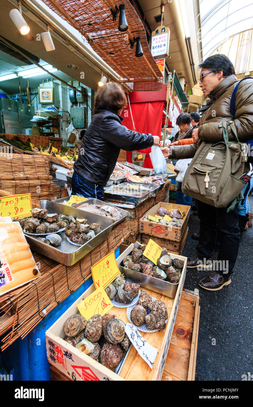 Kuromon Ichiba, food market in Osaka. Fish monger stall with various ...