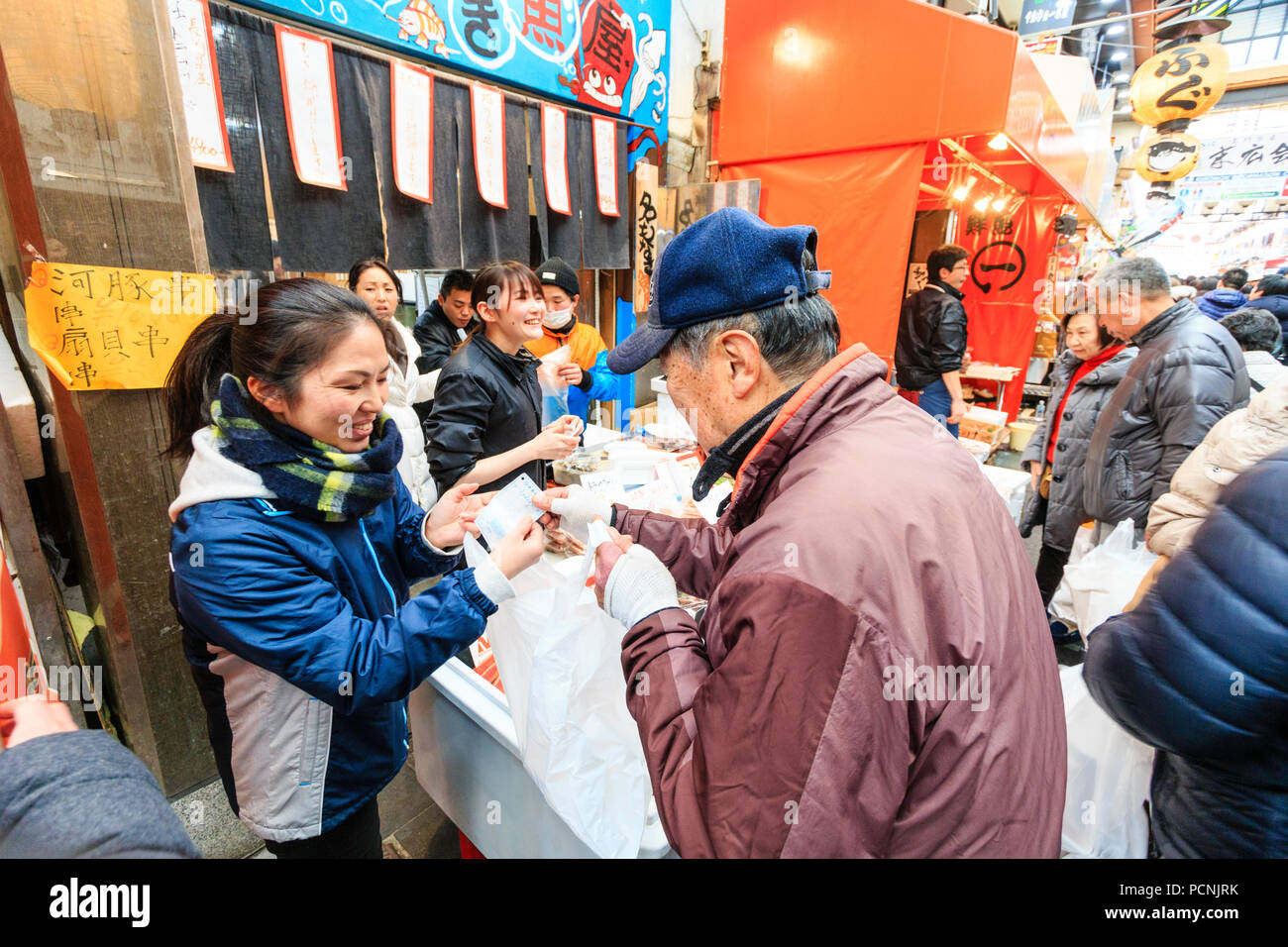 Woman handing over bag of food hi-res stock photography and images - Alamy