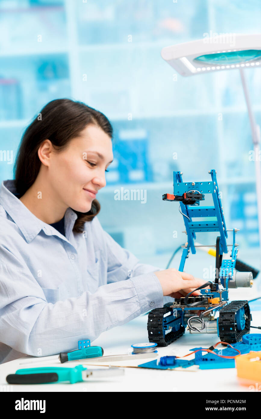 Student girl in electronics laboratory, experiment with microcontroller ...