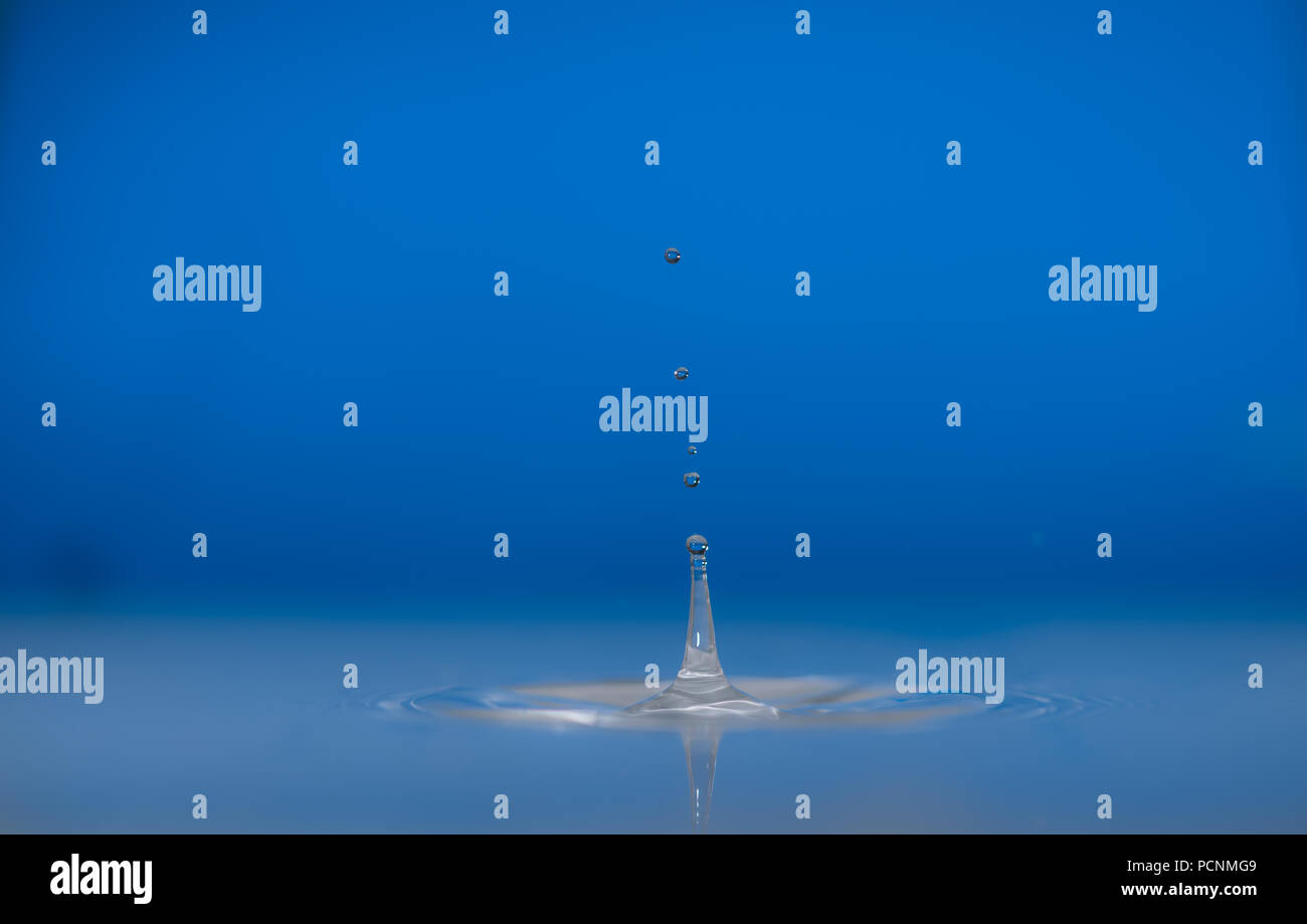 Water drop falling into water making a perfect droplet splash Stock ...