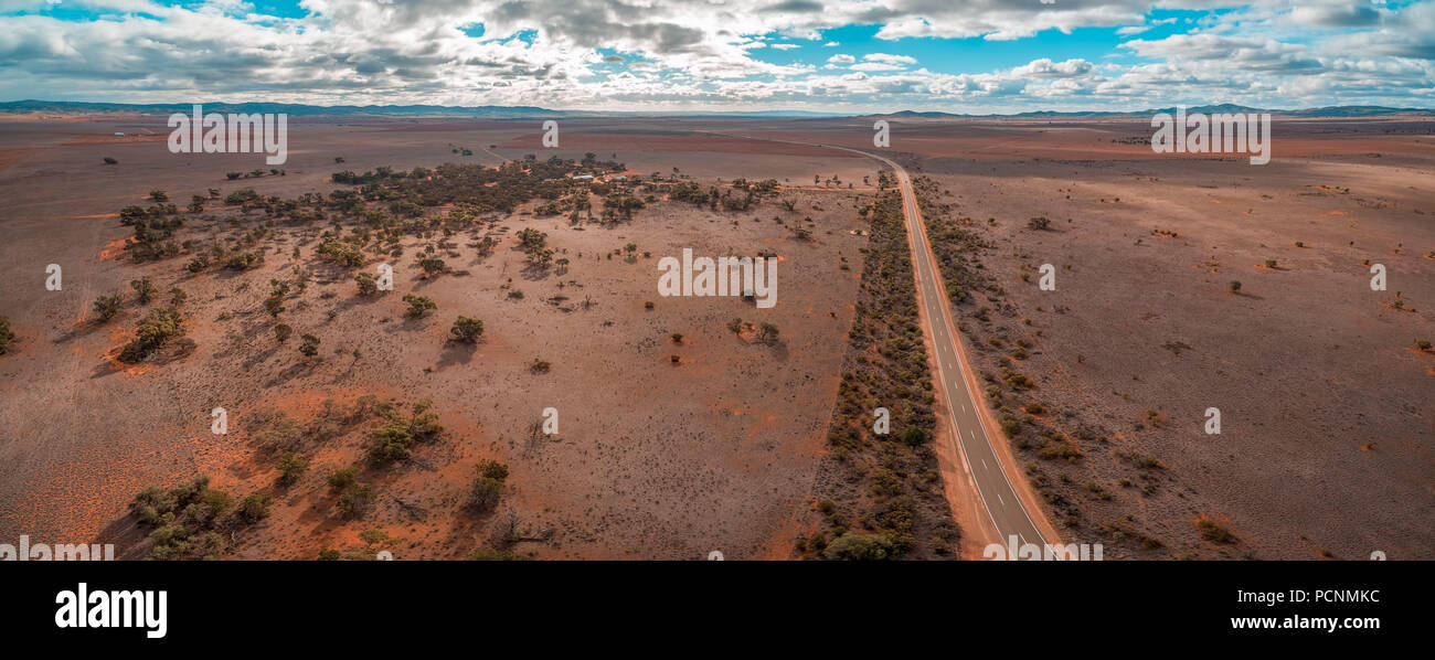 Aerial panorama of rural highway passing through vast plains in ...