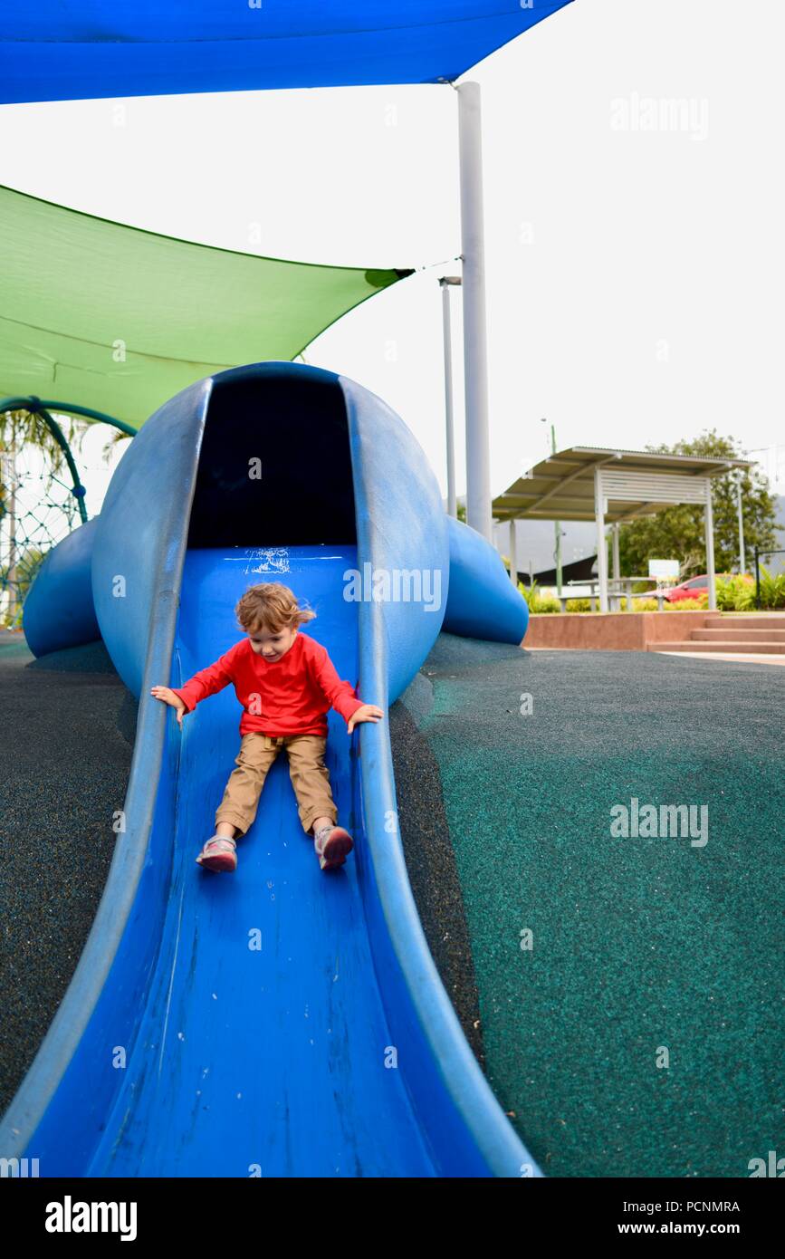 A child goes down a blue slide designed like a dugong, Cardwell ...