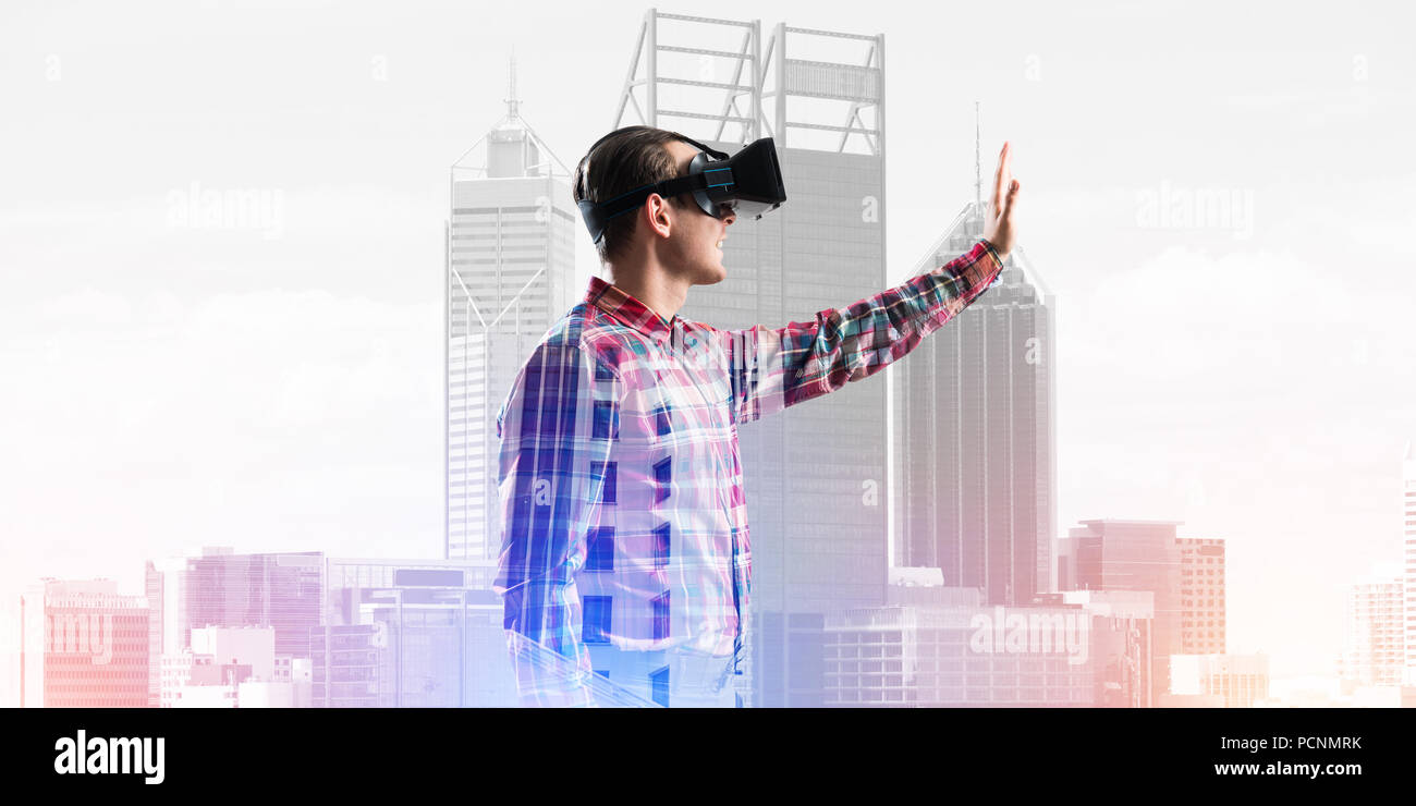 Guy wearing checked shirt and virtual mask stretching hand to touch ...