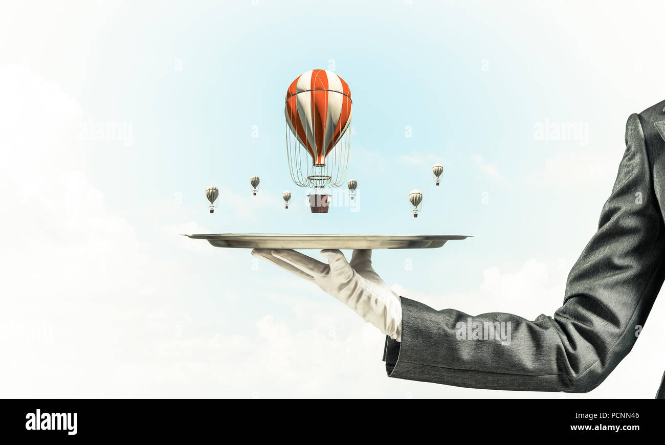 Hand of waitress presenting balloons on tray Stock Photo - Alamy