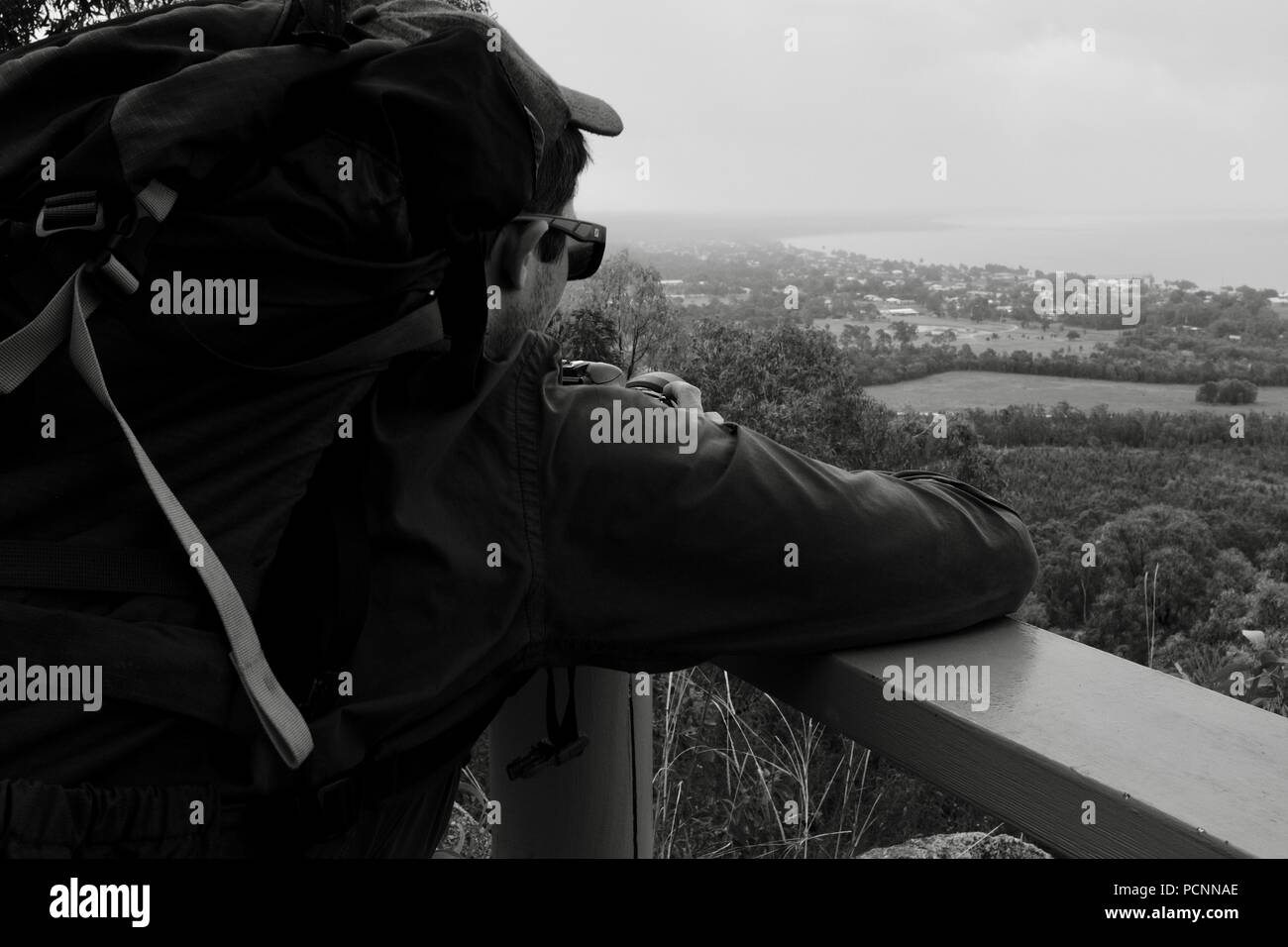 Man taking a photo from a lookout in black and white, Cardwell ...