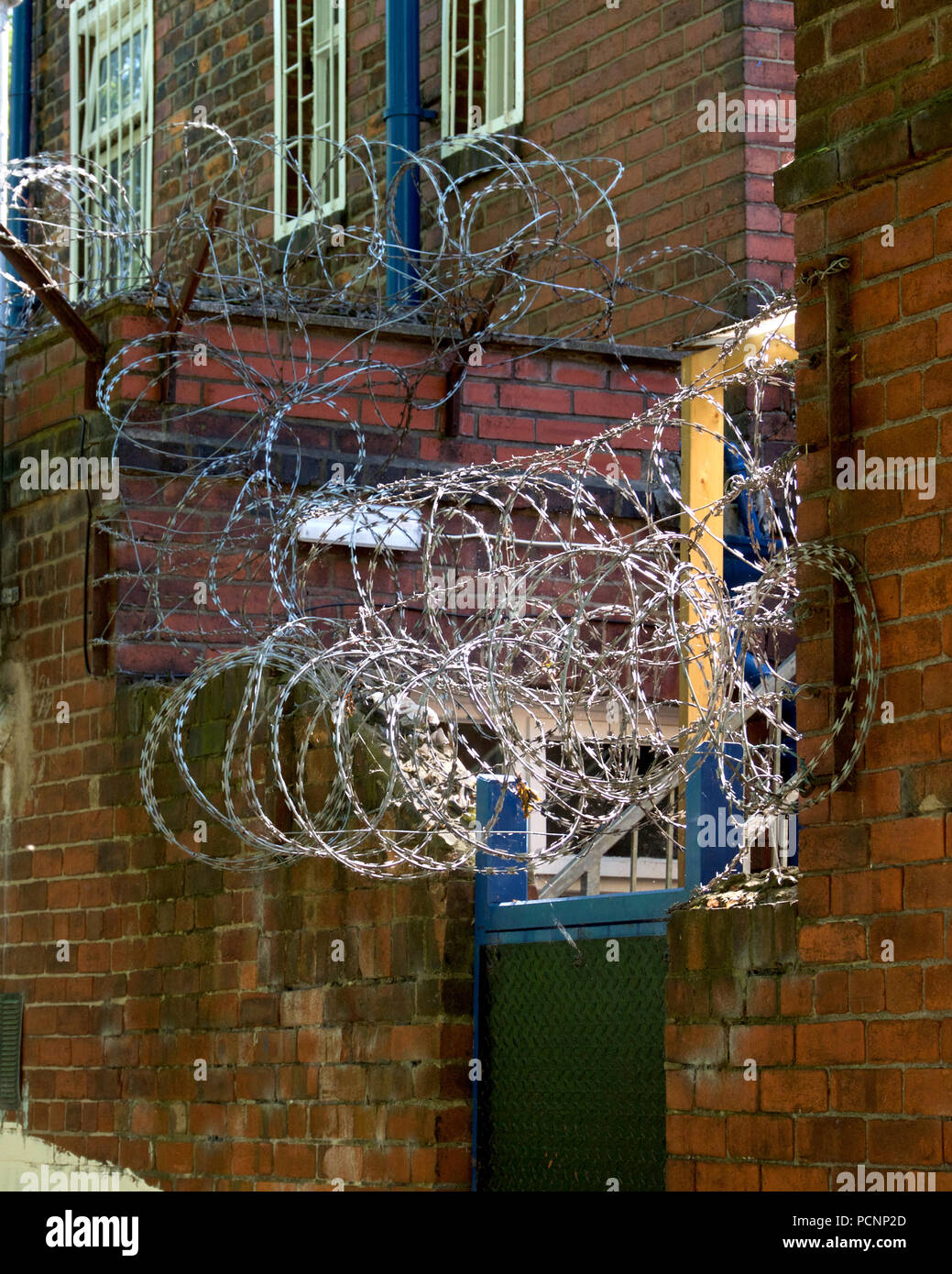 Razor wire at the back of house in Manchester Stock Photo - Alamy