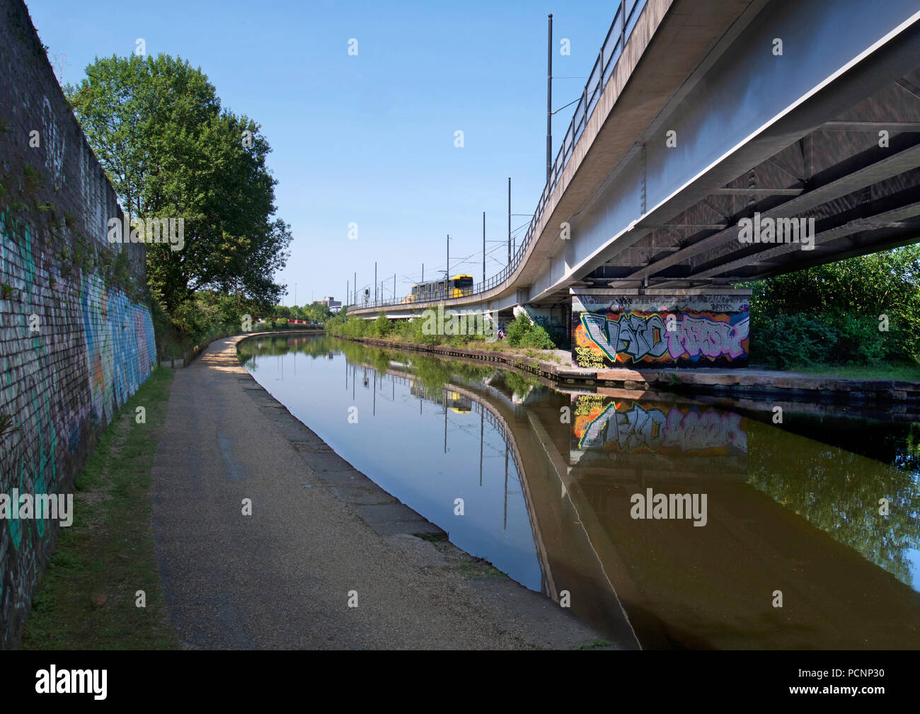 Yellow tram on the Manchester Metrolink above the Bridgewater Canal ...