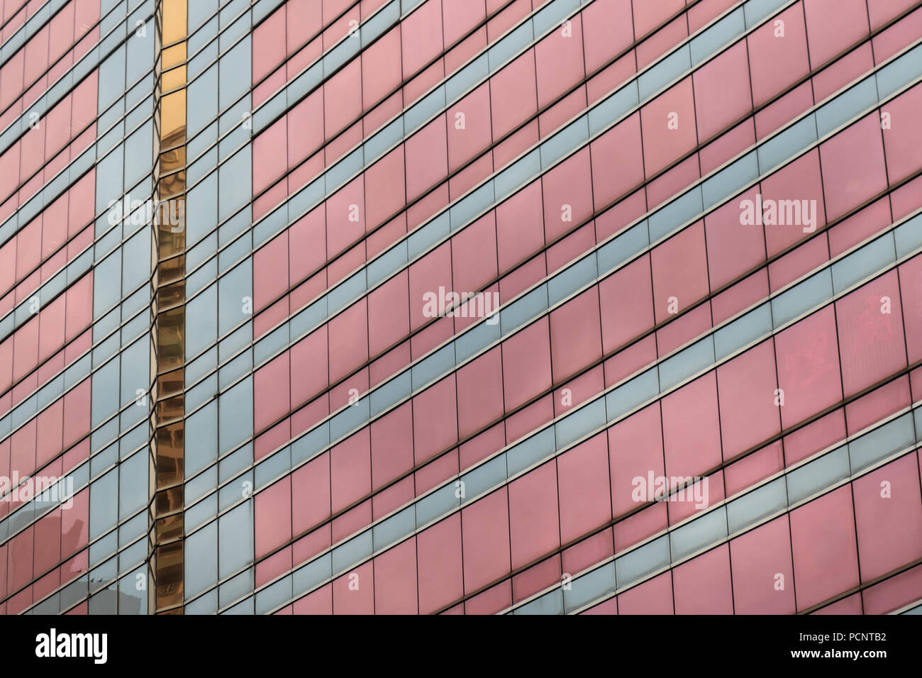 Modern building pink glass facade with light city reflections Stock ...