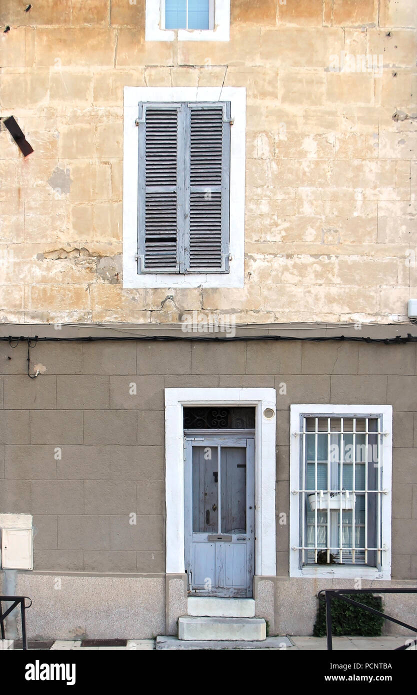Old derelict house with grunge facade and wrecked windows and entrance ...
