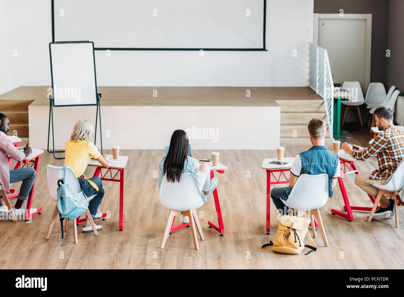 Group university students sitting desks hi-res stock photography and ...