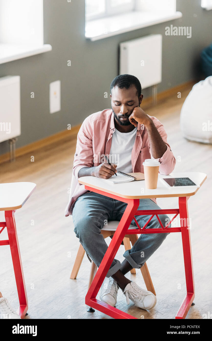 bored african american student sitting at desk during lesson Stock ...