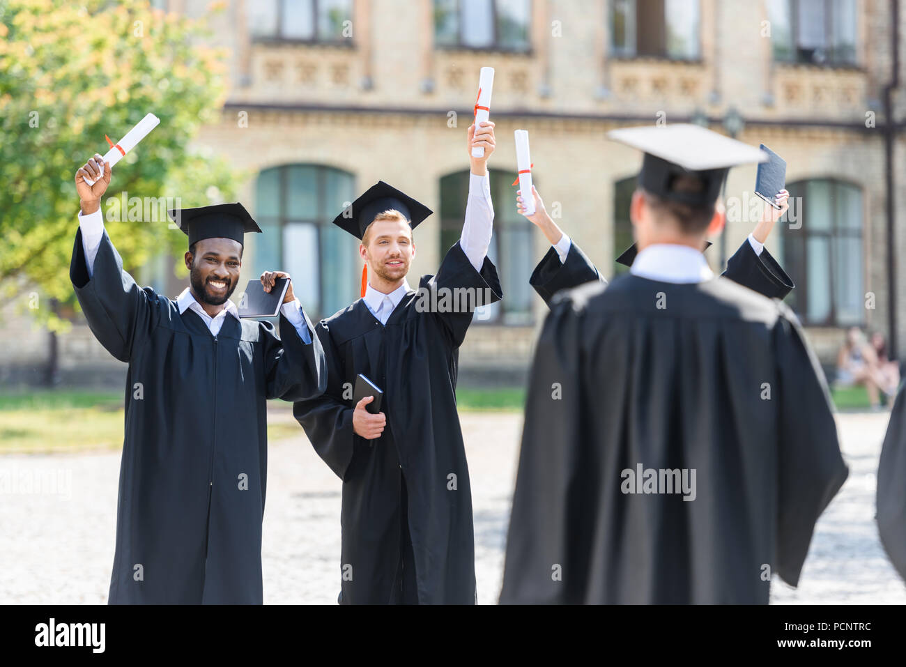 Young graduated students diplomas hi-res stock photography and images ...