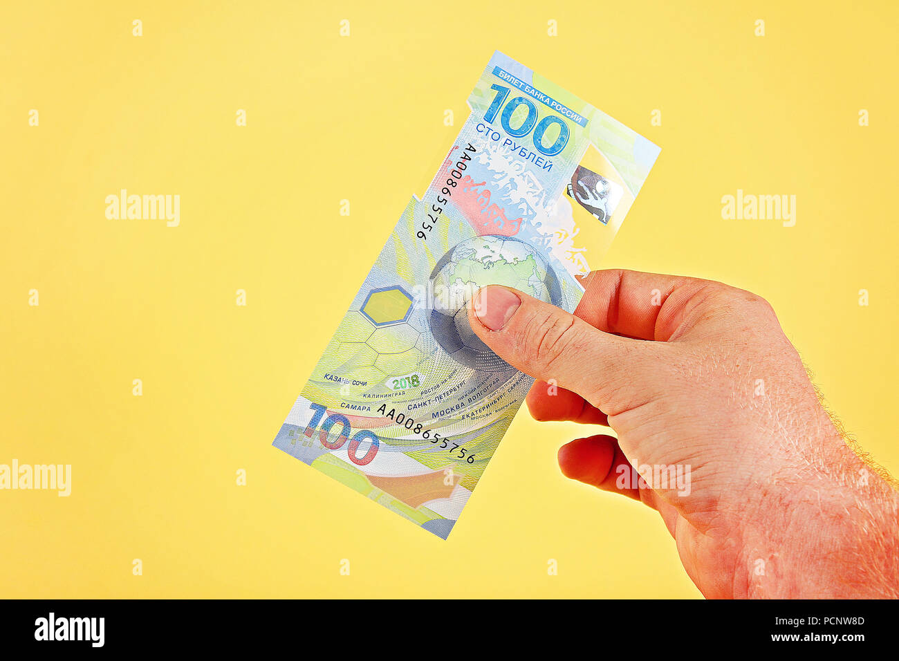 New Russian money 100 rubles. Plastic commemorative banknotes with ...