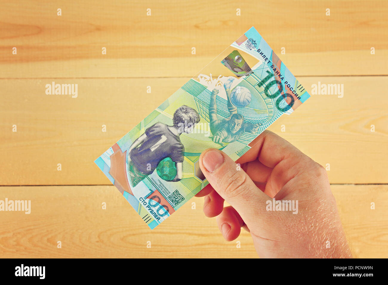 New Russian money 100 rubles. Plastic commemorative banknotes with ...