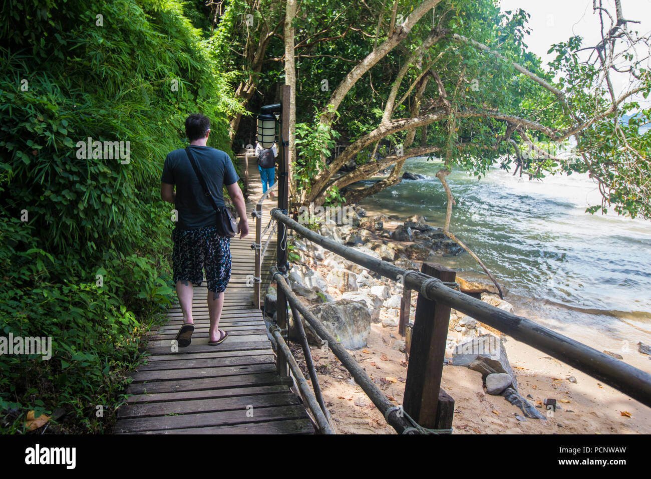 Cliffside wooden path over the water from Ao Nang beach to secluded ...