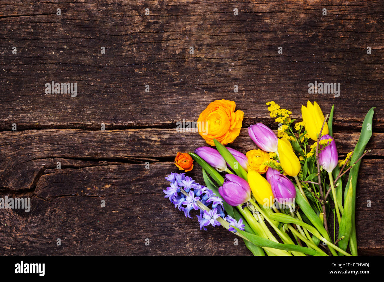 Colorful spring flowers on wood Stock Photo - Alamy