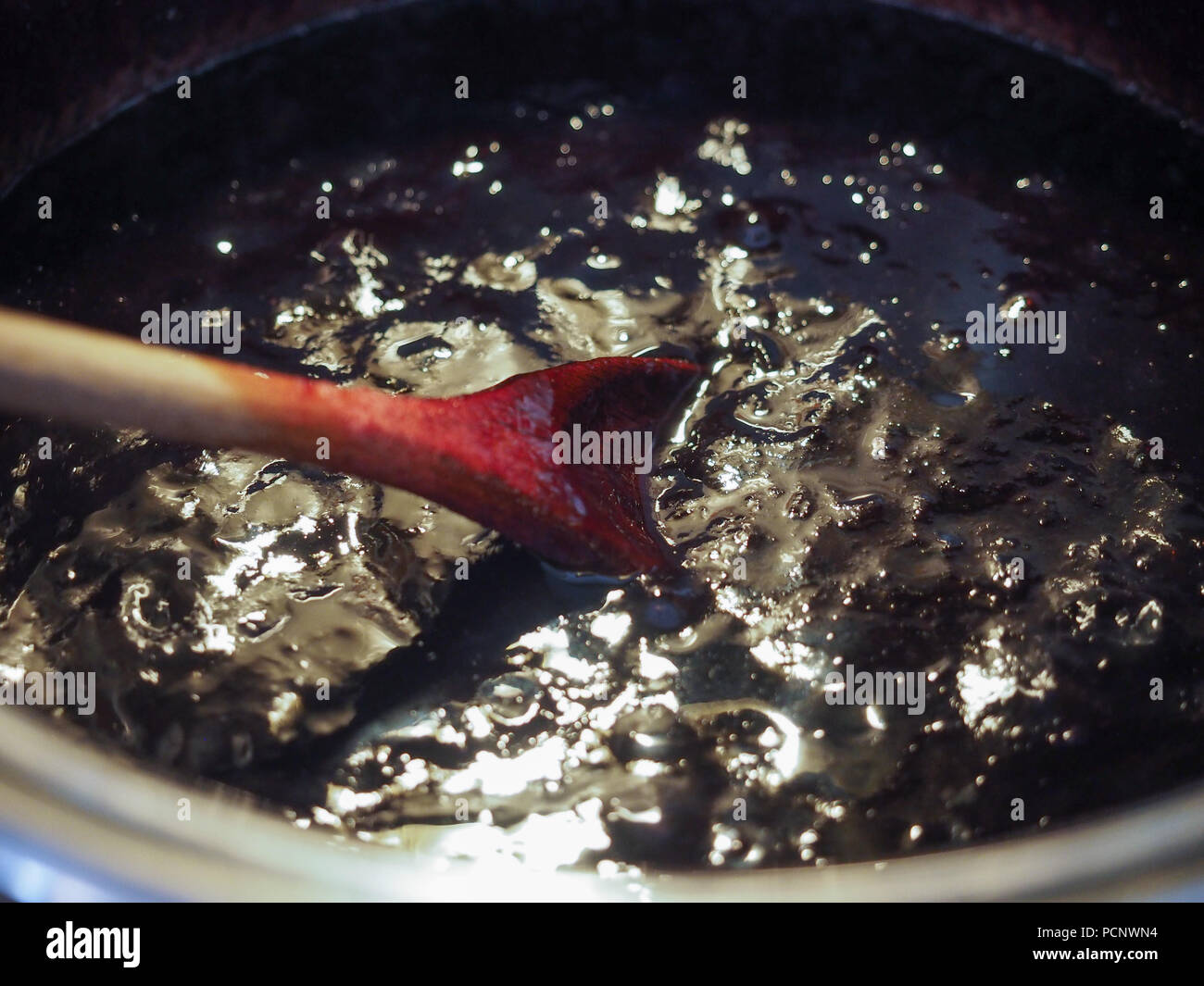 Prune fruit jam boiling in a pot Stock Photo - Alamy