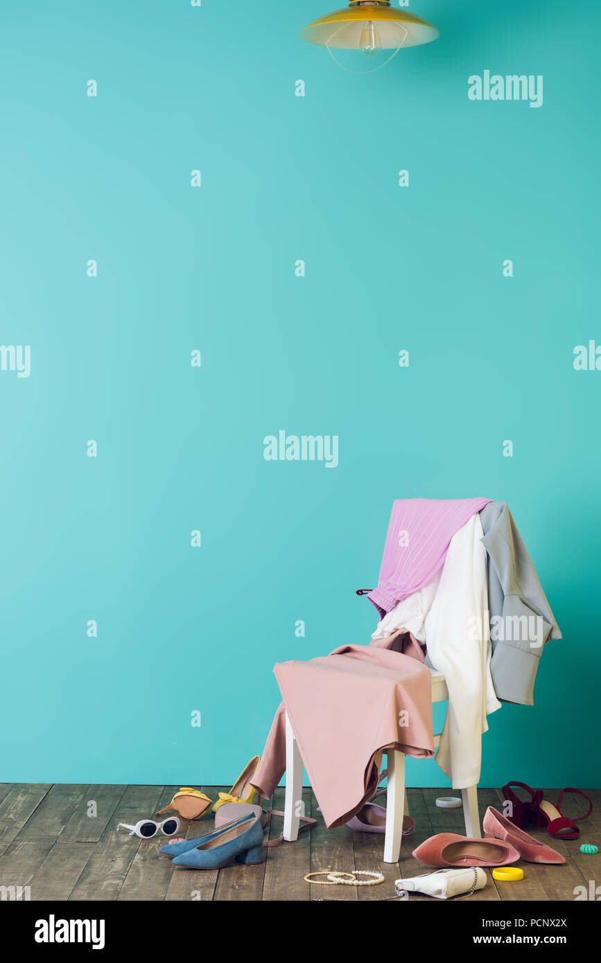 messy room with trendy clothes and shoes on chair Stock Photo - Alamy