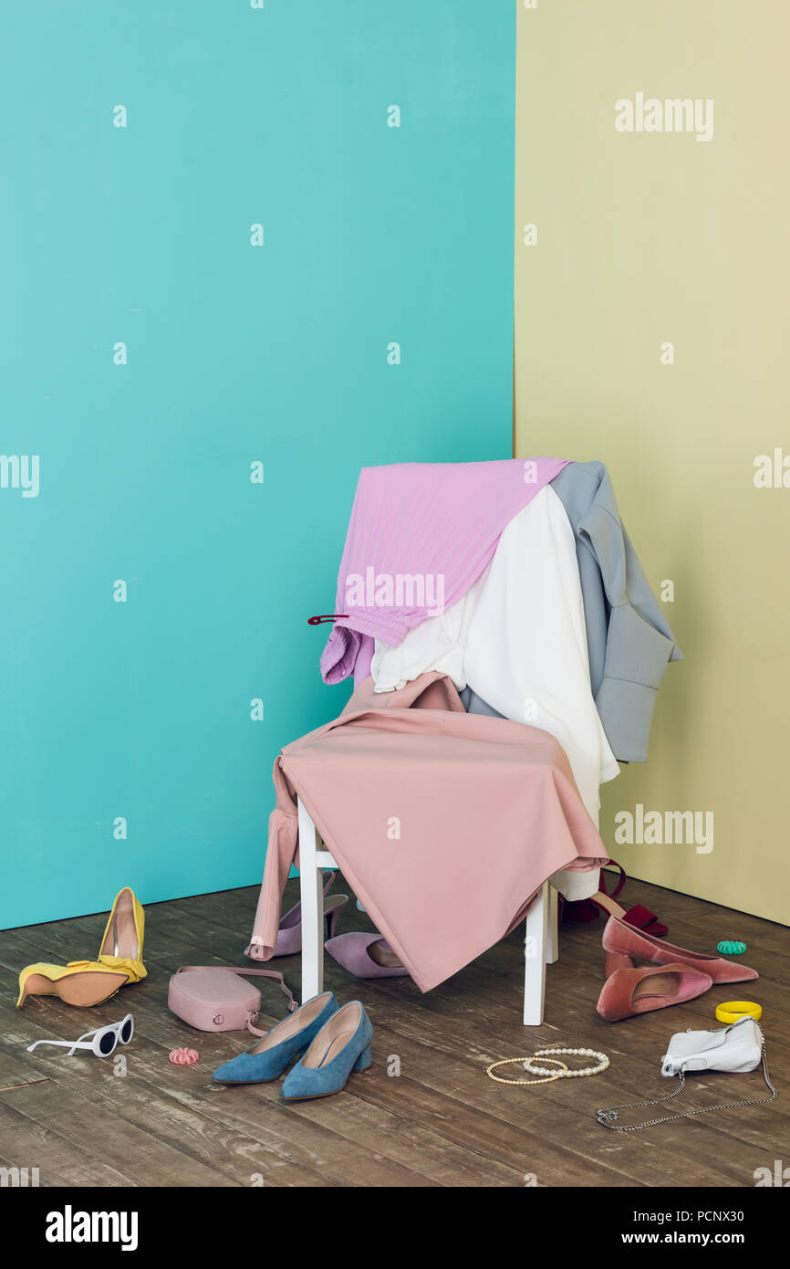 messy room with elegant clothes and shoes on chair Stock Photo - Alamy
