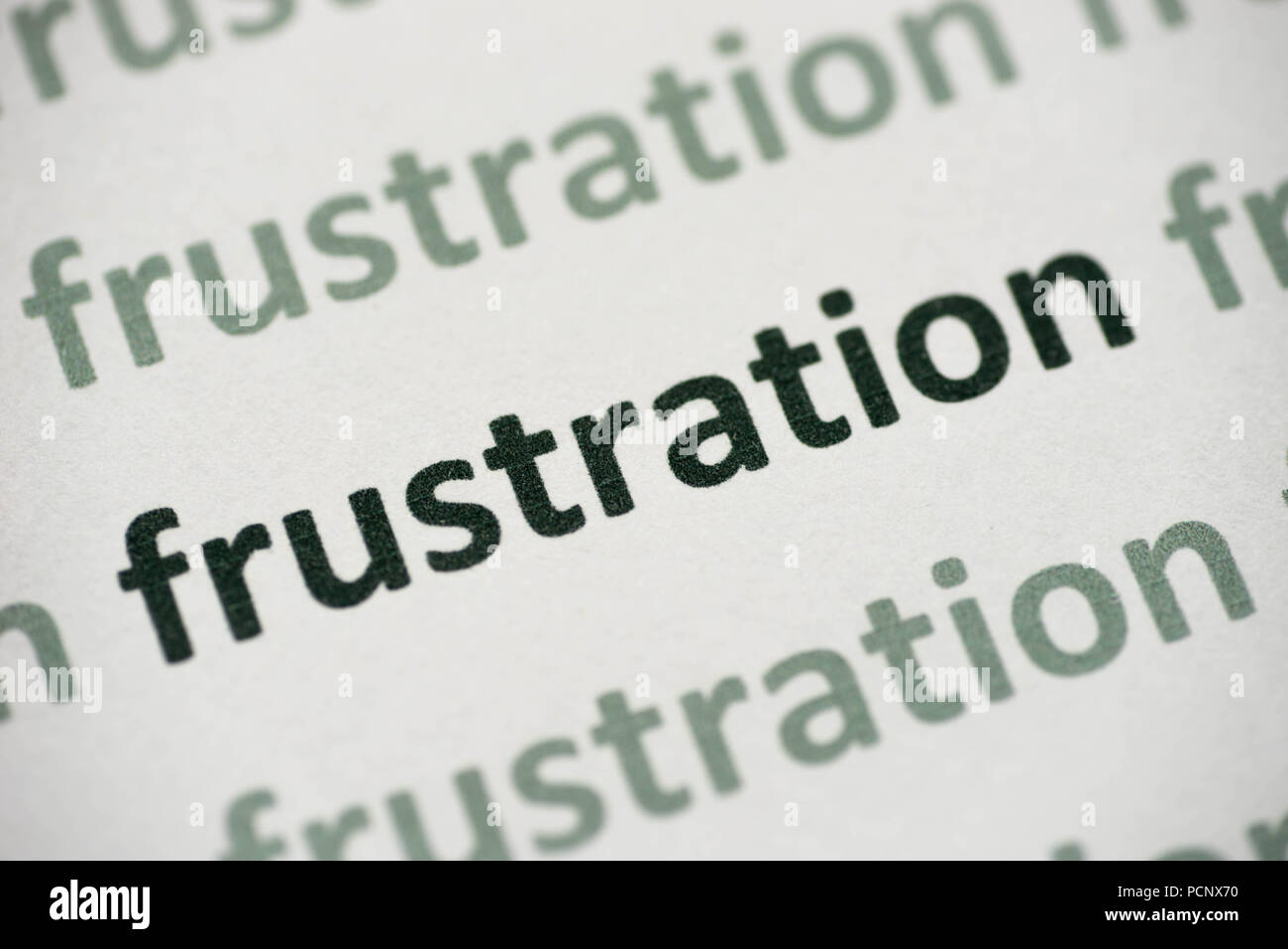 word frustration printed on white paper macro Stock Photo - Alamy