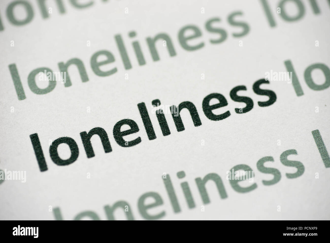 word loneliness printed on white paper macro Stock Photo - Alamy