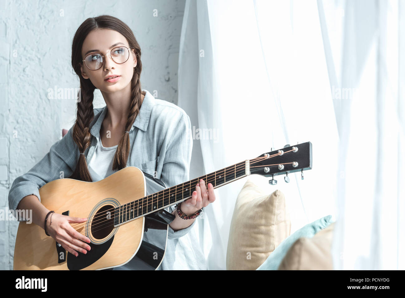 Teenage Girl Playing Acoustic Guitar