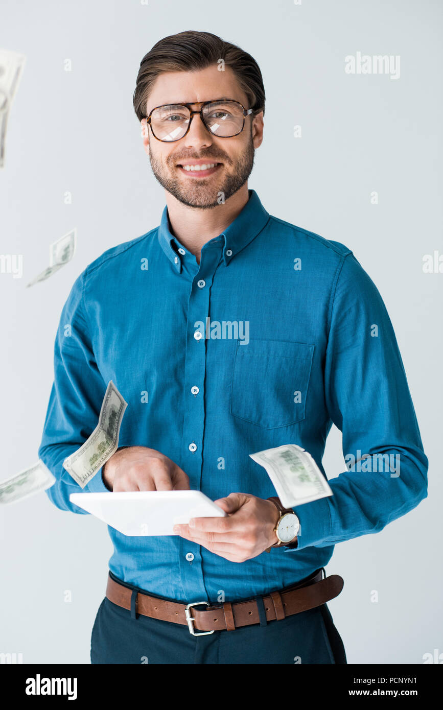 money falling around young man with tablet isolated on white Stock ...