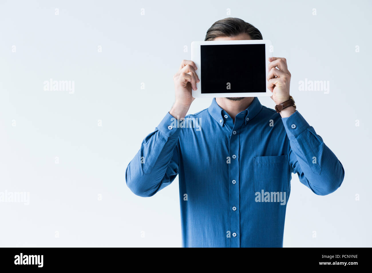 man covering face with tablet with blank screen isolated on white Stock ...