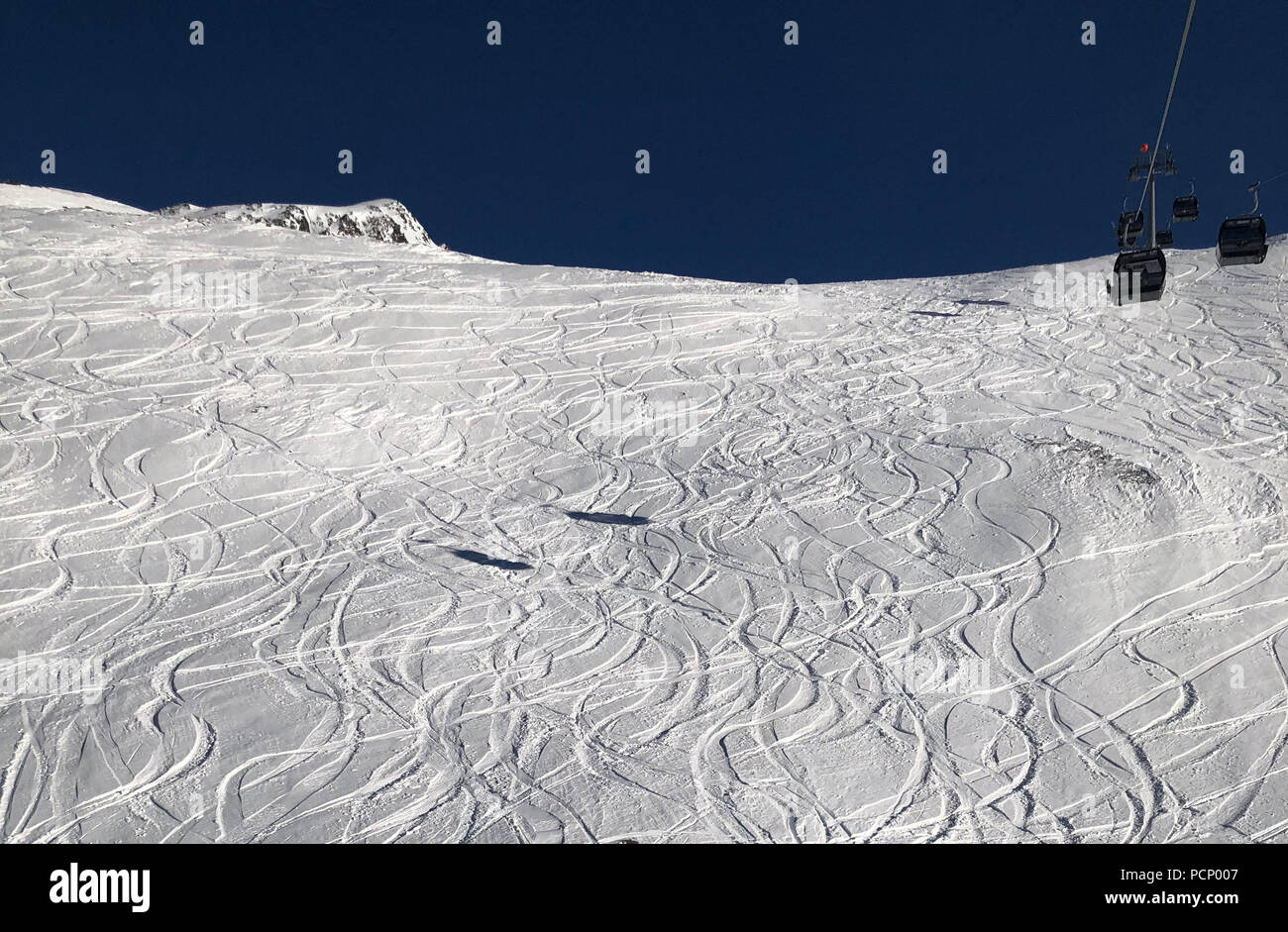 Ski runway with ski tracks and a lift at Ötztal Stock Photo - Alamy