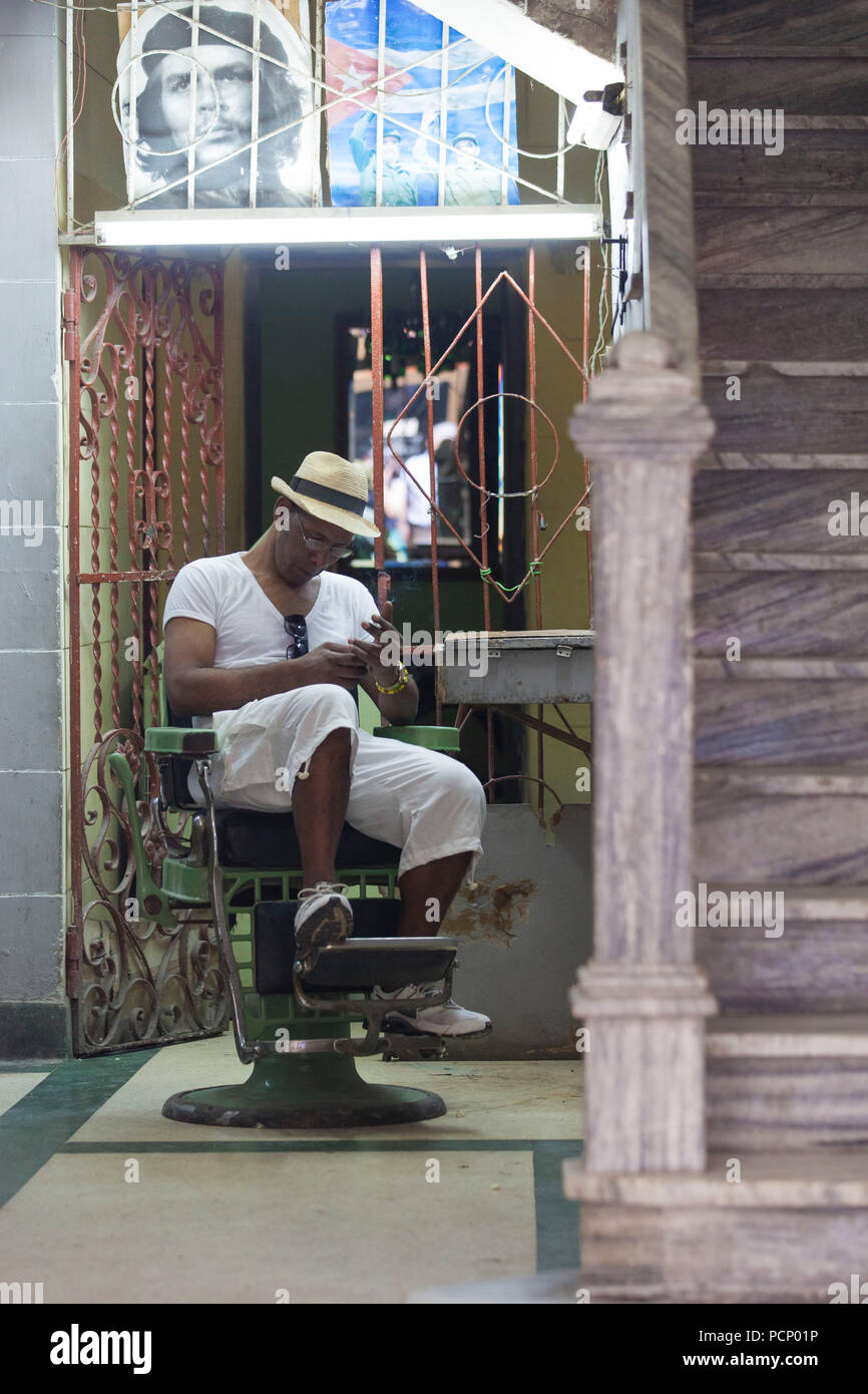 Cuban facing his mobile phone hi-res stock photography and images - Alamy