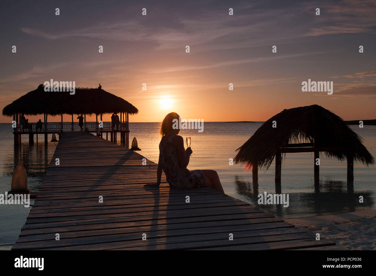 Caribbean, Cuba, Cayo Santa Maria, woman on jetty, sunset in the ...