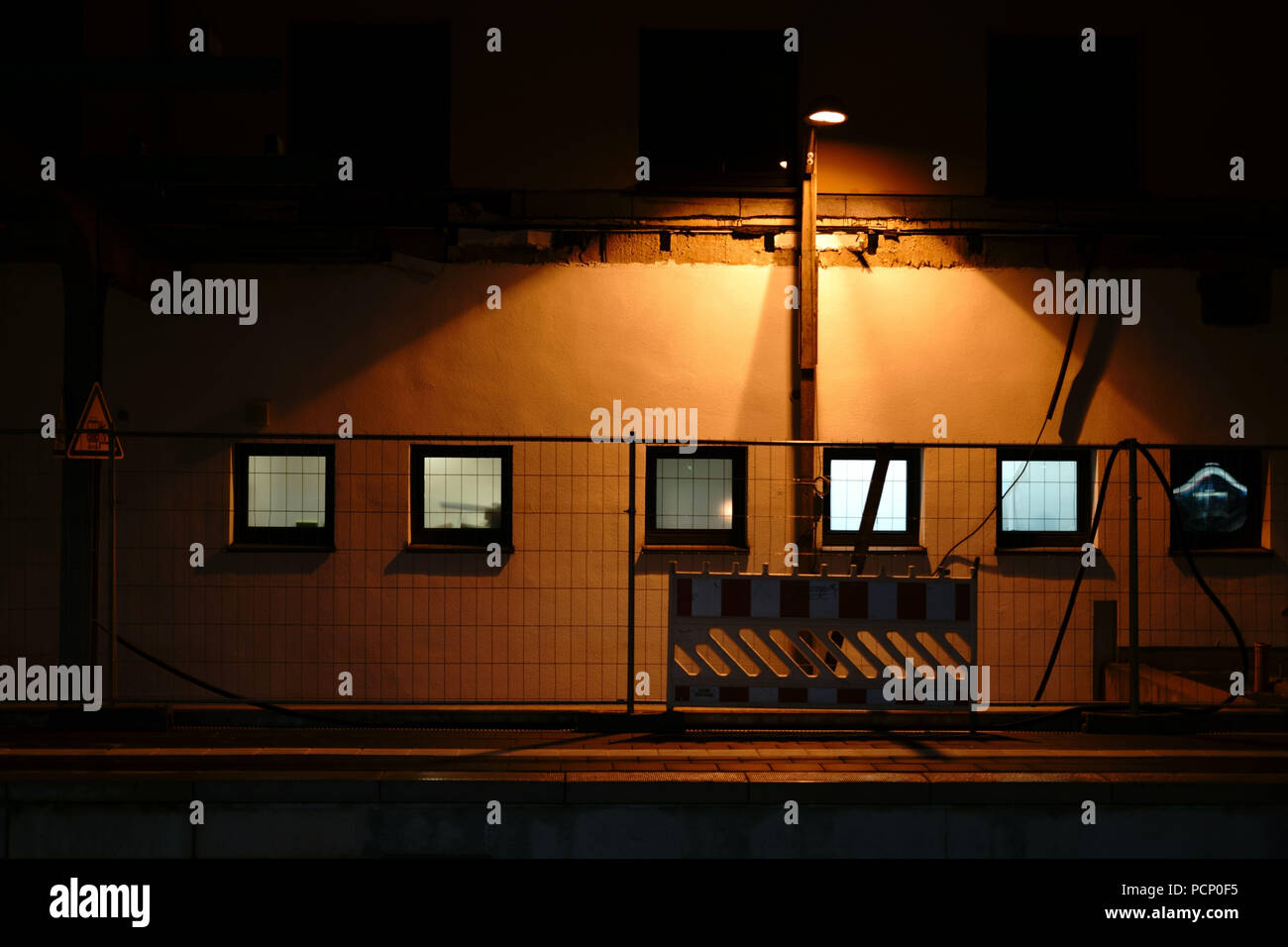 The light beam of a street lamp is falling at a construction site at a ...