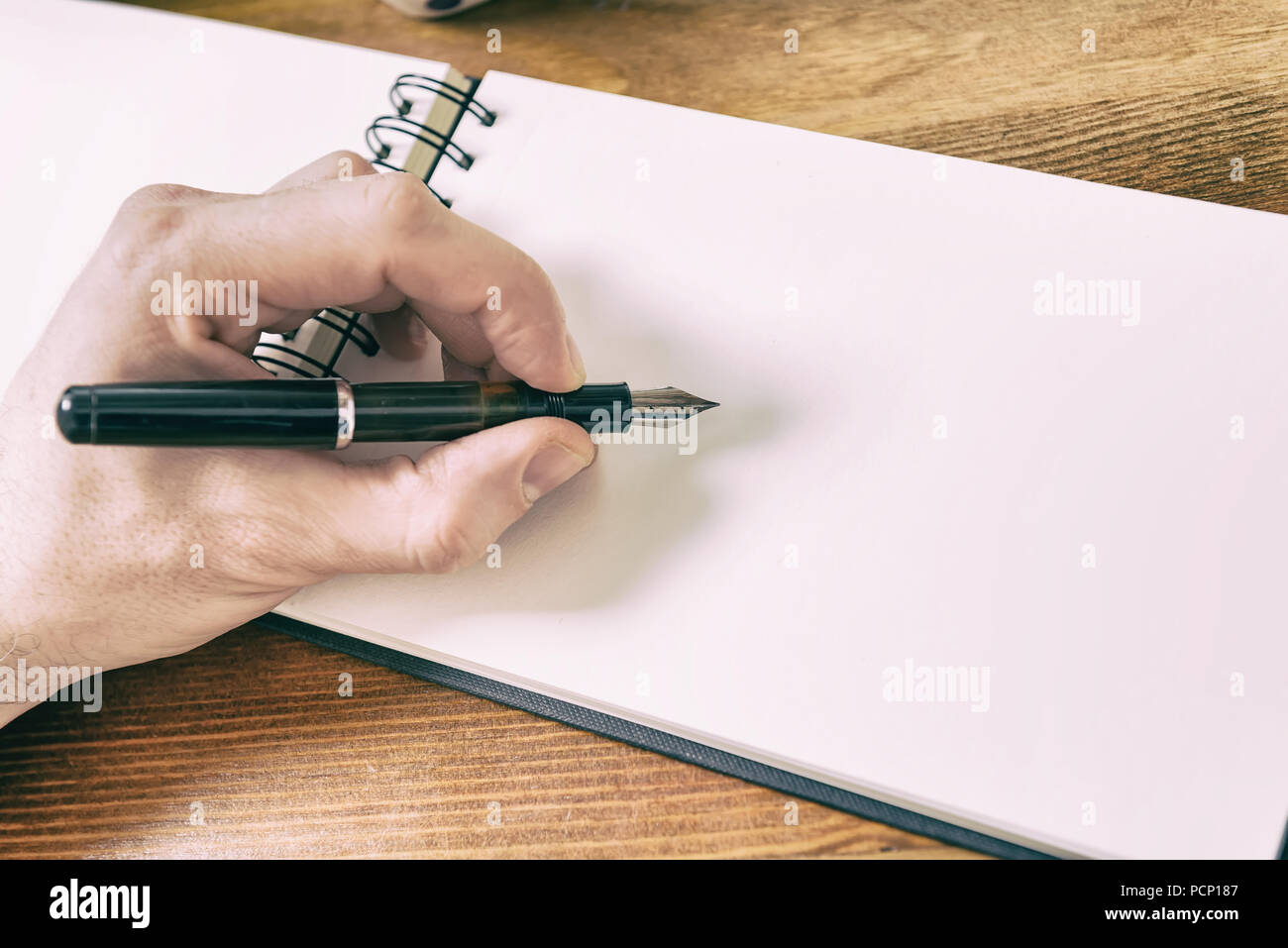 One man writing hand pen notepad hi-res stock photography and images ...