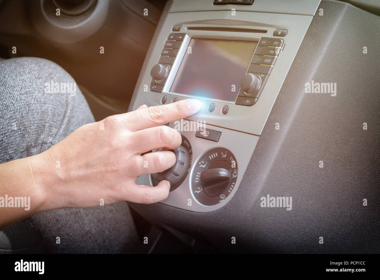 Driver using touchscreen to adjust car navigation or other systems ...