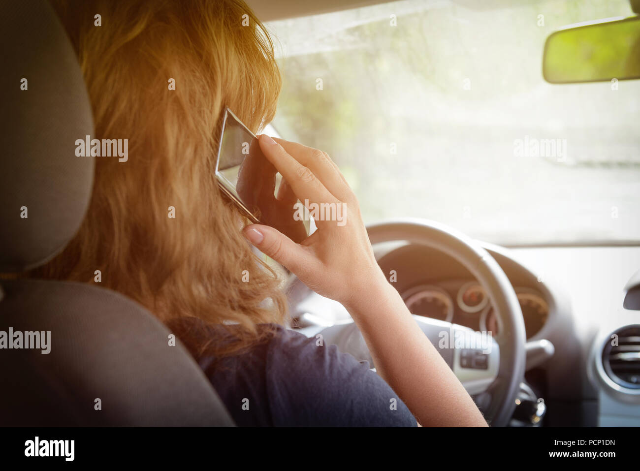 Woman using phone while driving the car. Risky driving behaviors ...